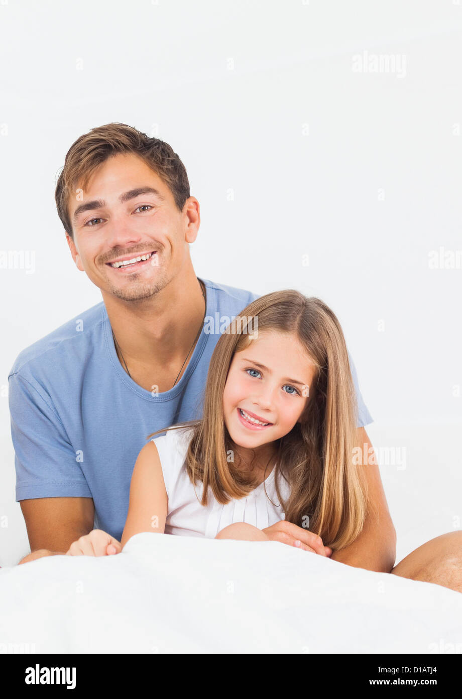 Father and daughter on the bed Stock Photo - Alamy