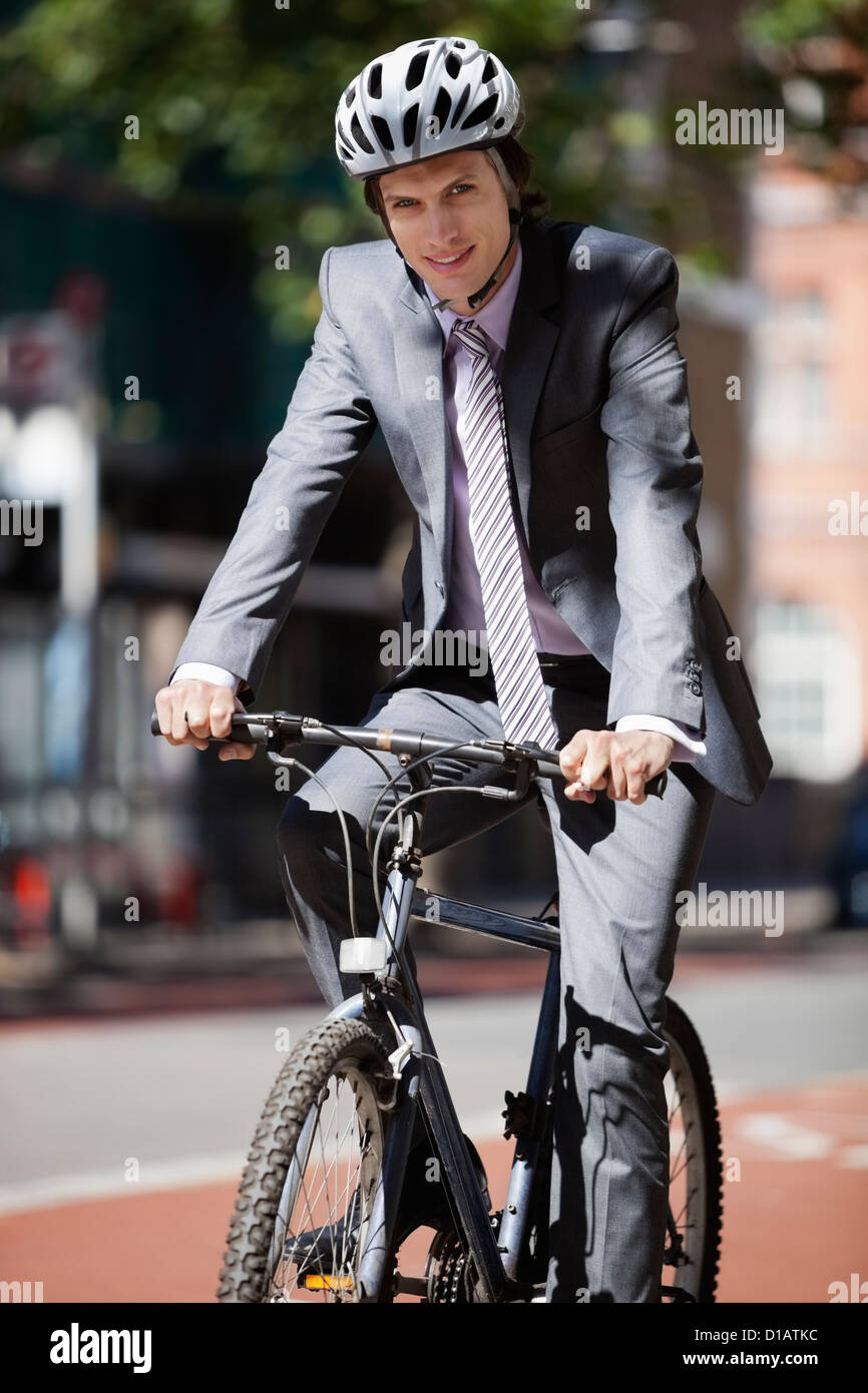 Portrait young businessman riding bicycle Stock Photo - Alamy