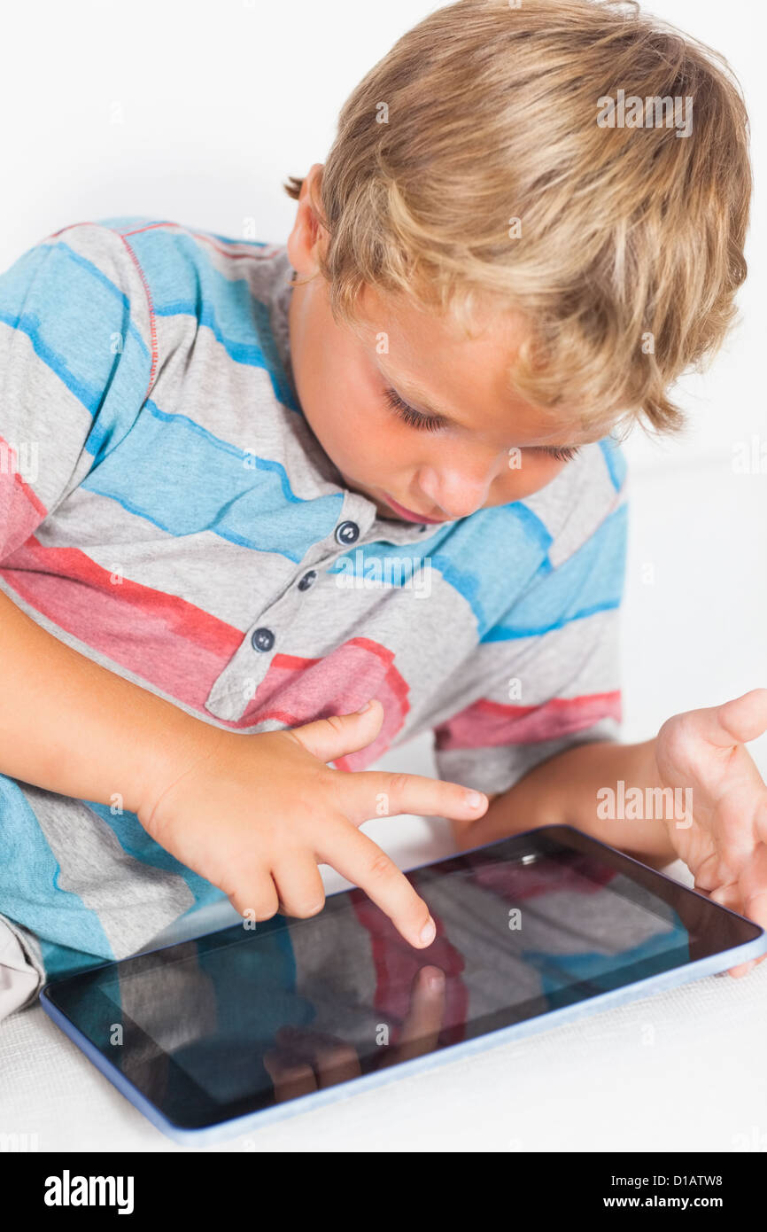 Happy boy touching a tablet Stock Photo - Alamy