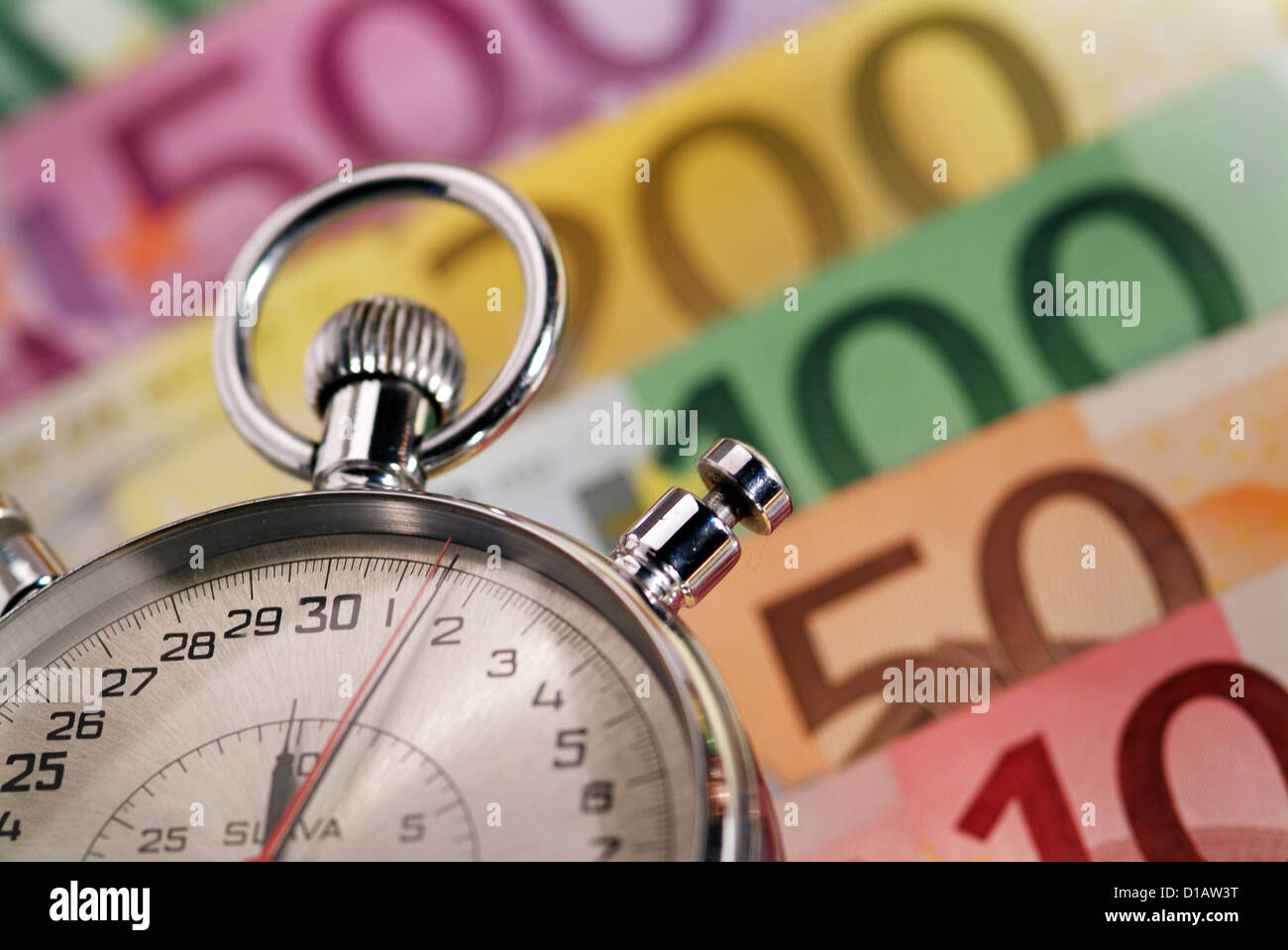 Time is money. Stopwatch and the European currency Stock Photo - Alamy