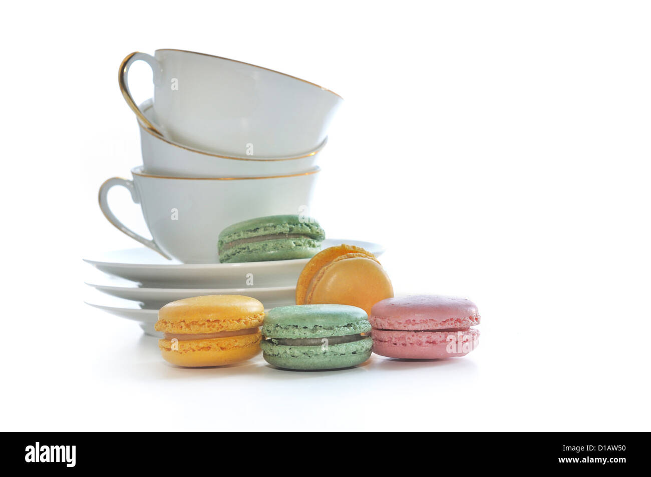 porcelain coffee cups piled behind macaroons different colors Stock ...