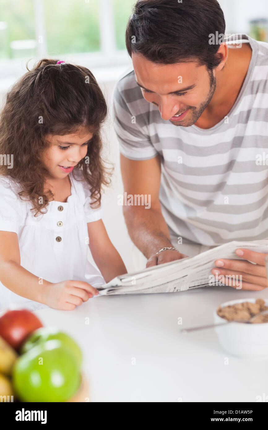 Dad and daughter reading a newspaper Stock Photo - Alamy