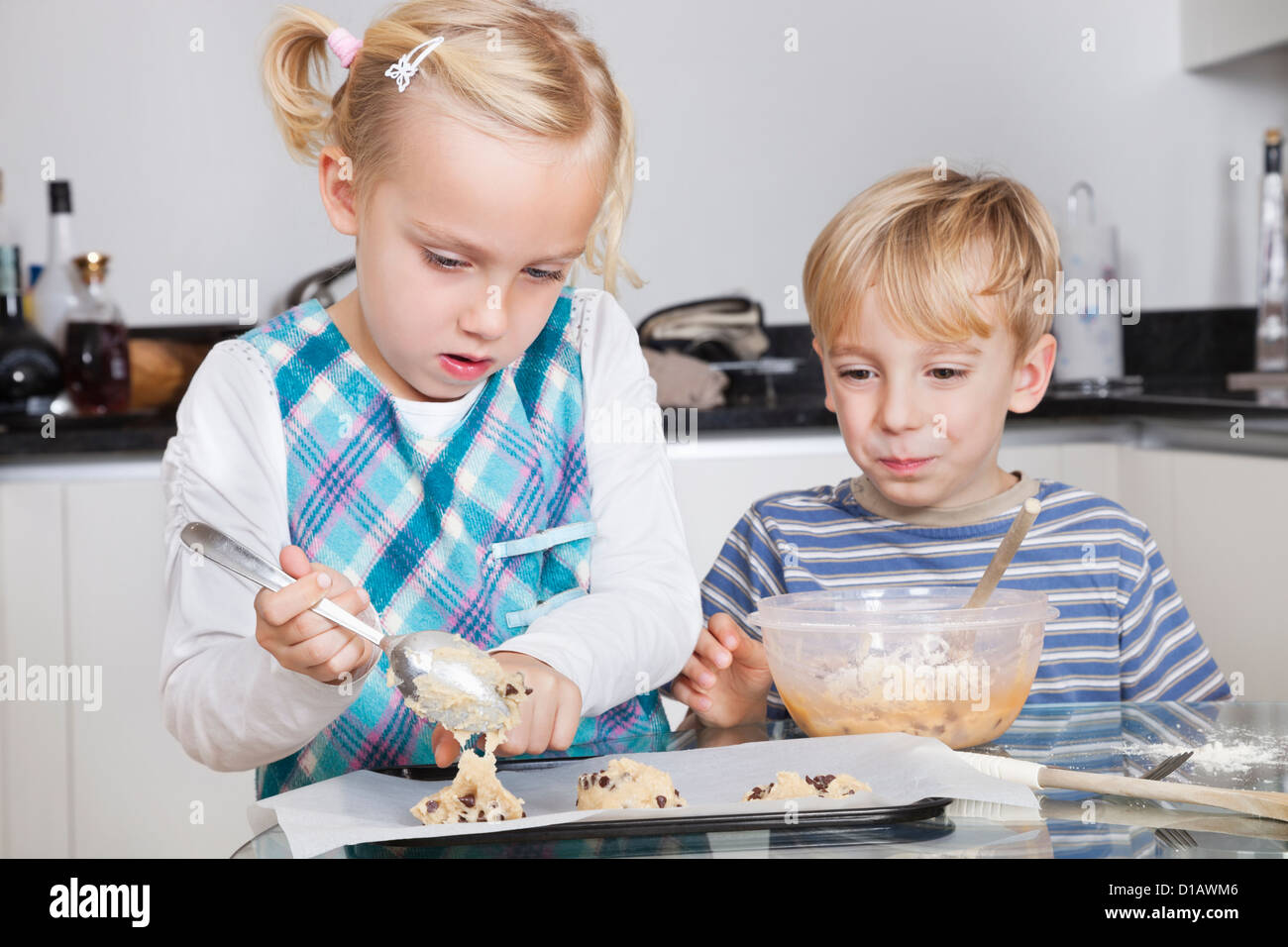Happy brother sister baking cookies in kitchen Stock Photo - Alamy