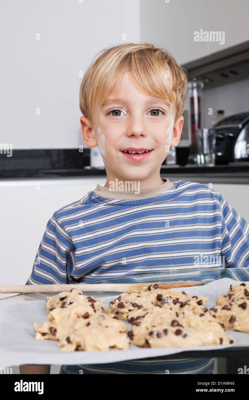 Portrait happy young boy in front baking tray cookies Stock Photo - Alamy