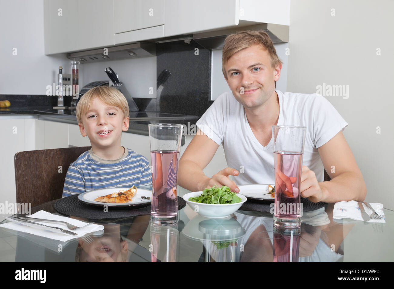 Portrait father son smiling at breakfast table Stock Photo - Alamy