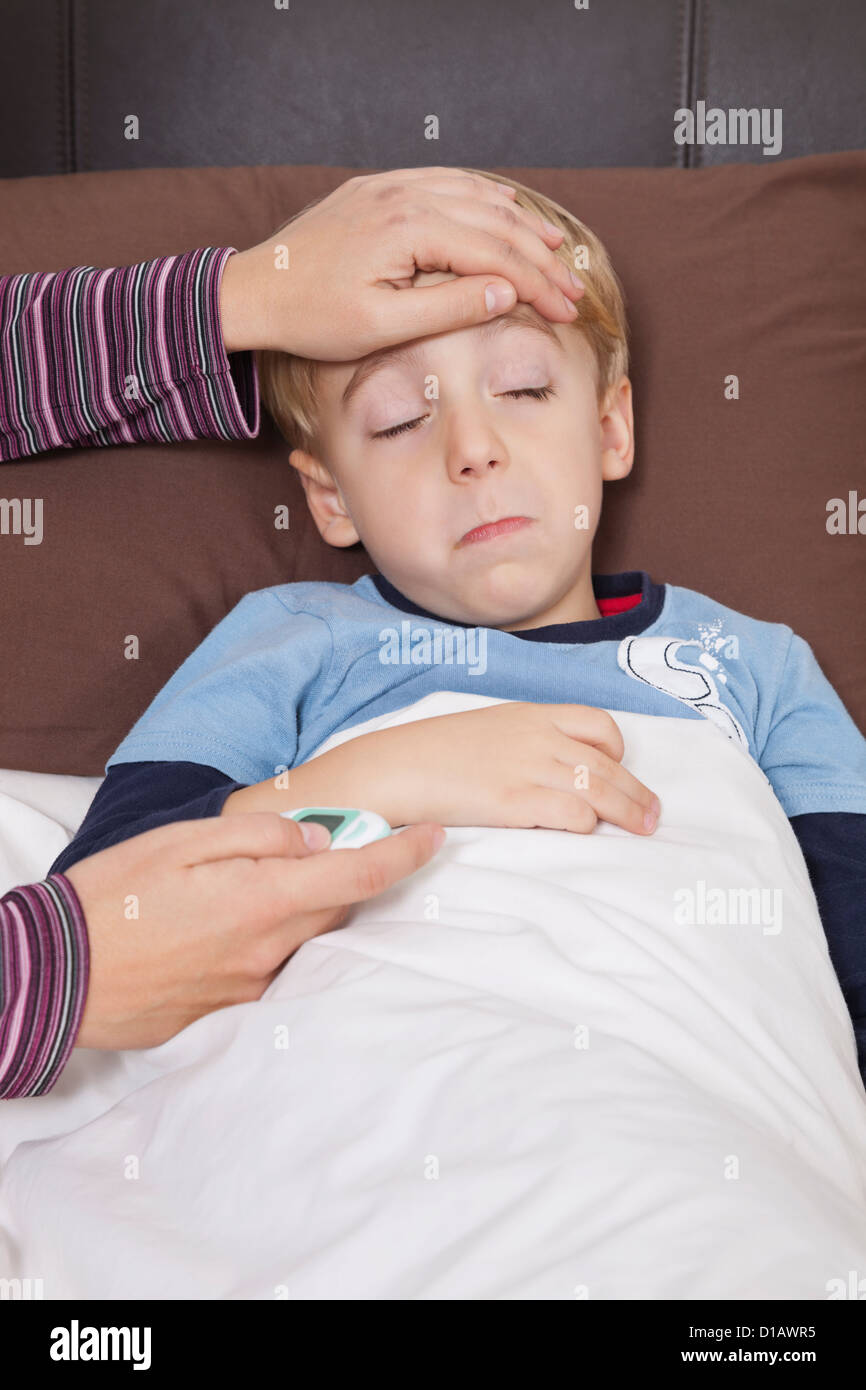 mother rmometer checking little boy's temperature Stock Photo - Alamy
