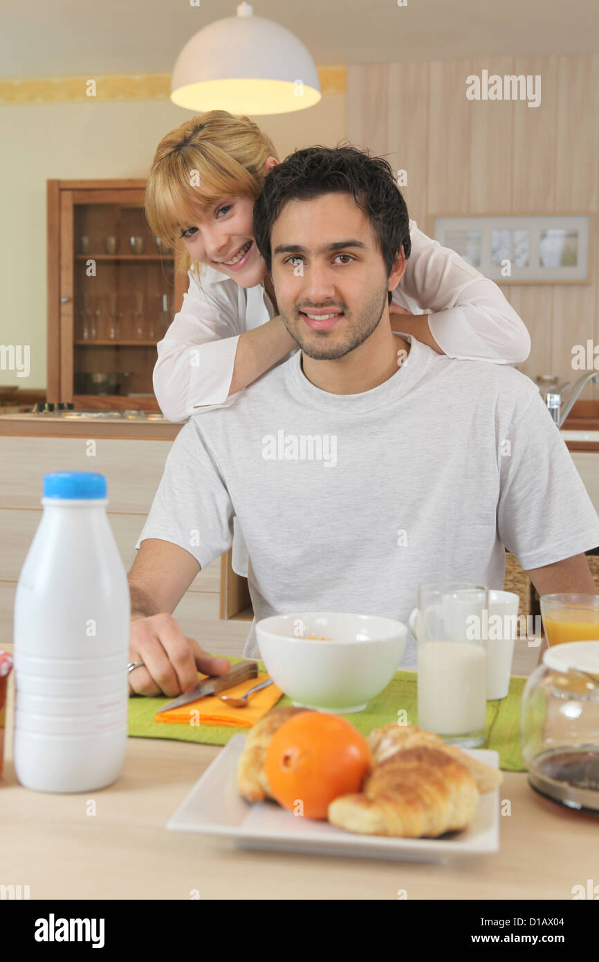 Smiling boy and girl breakfasting Stock Photo - Alamy