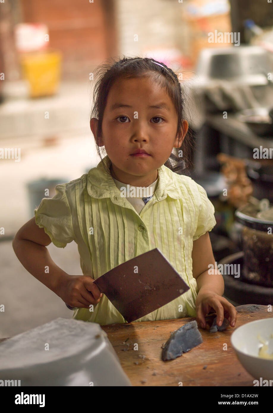 Chinese Kid With A Huge Knife At A Butcher Workshop, Lijiang, Yunnan ...