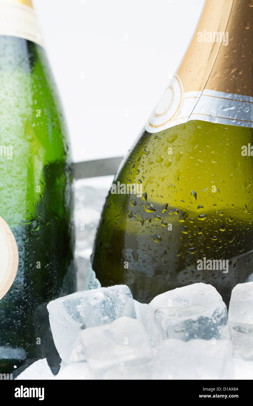 Two bottles of champagne chilling on ice Stock Photo - Alamy