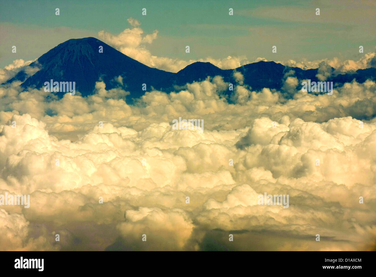 Volcano landscape over the clouds in Indonesia Stock Photo - Alamy
