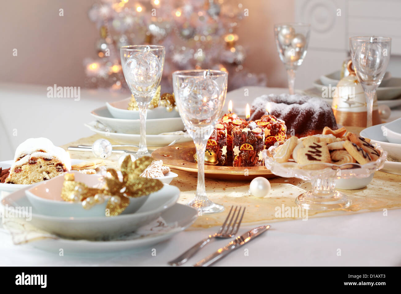 Decorated Christmas table with tree in background Stock Photo - Alamy