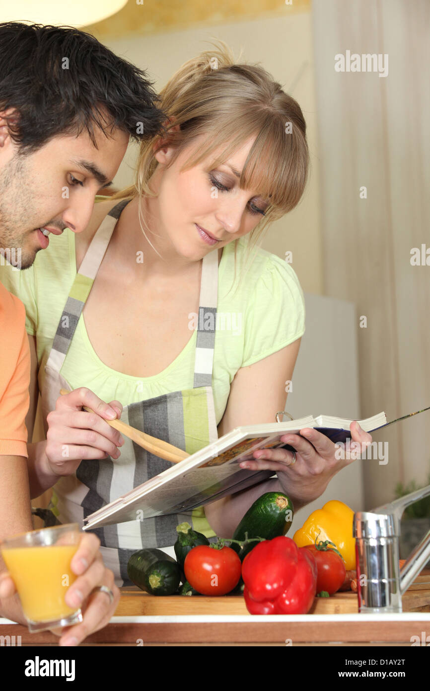 Couple following recipe Stock Photo - Alamy
