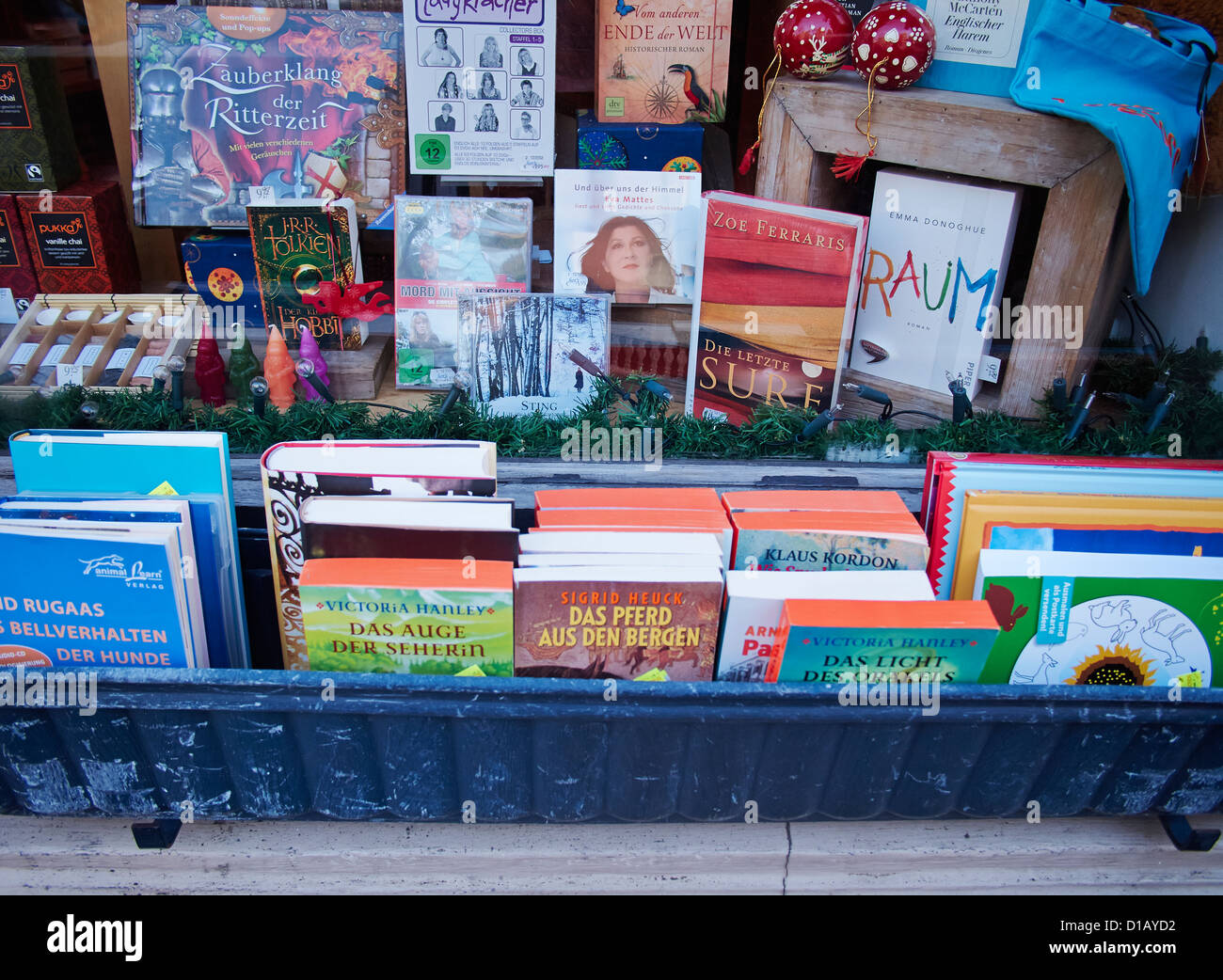 Antiquarians having a box with different books in front of the display ...