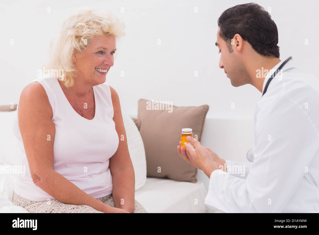 Doctor giving a prescription to patient Stock Photo - Alamy