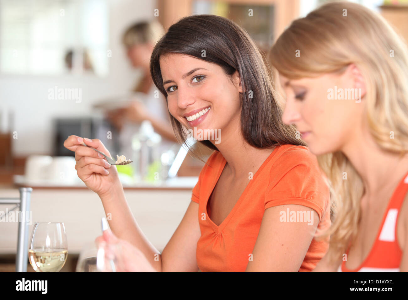 Girls eating in the kitchen Stock Photo - Alamy