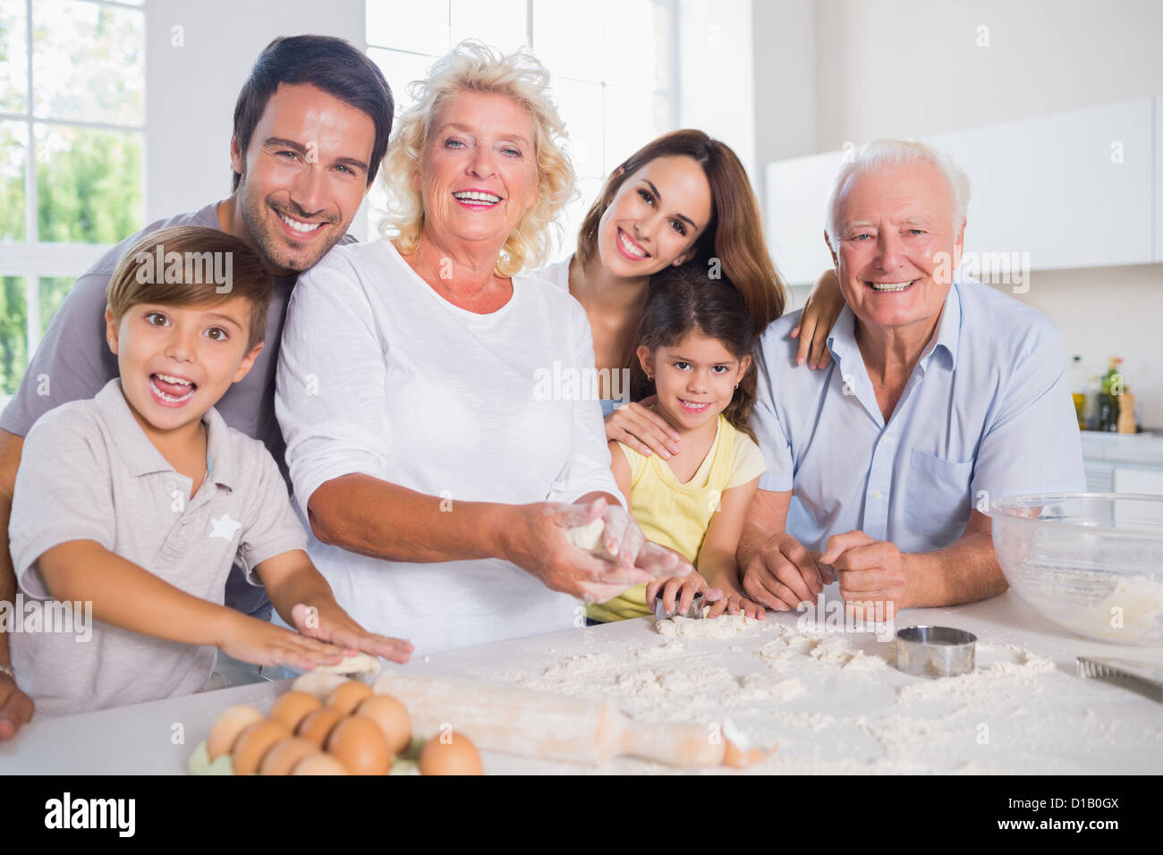 Smiling family baking together Stock Photo - Alamy