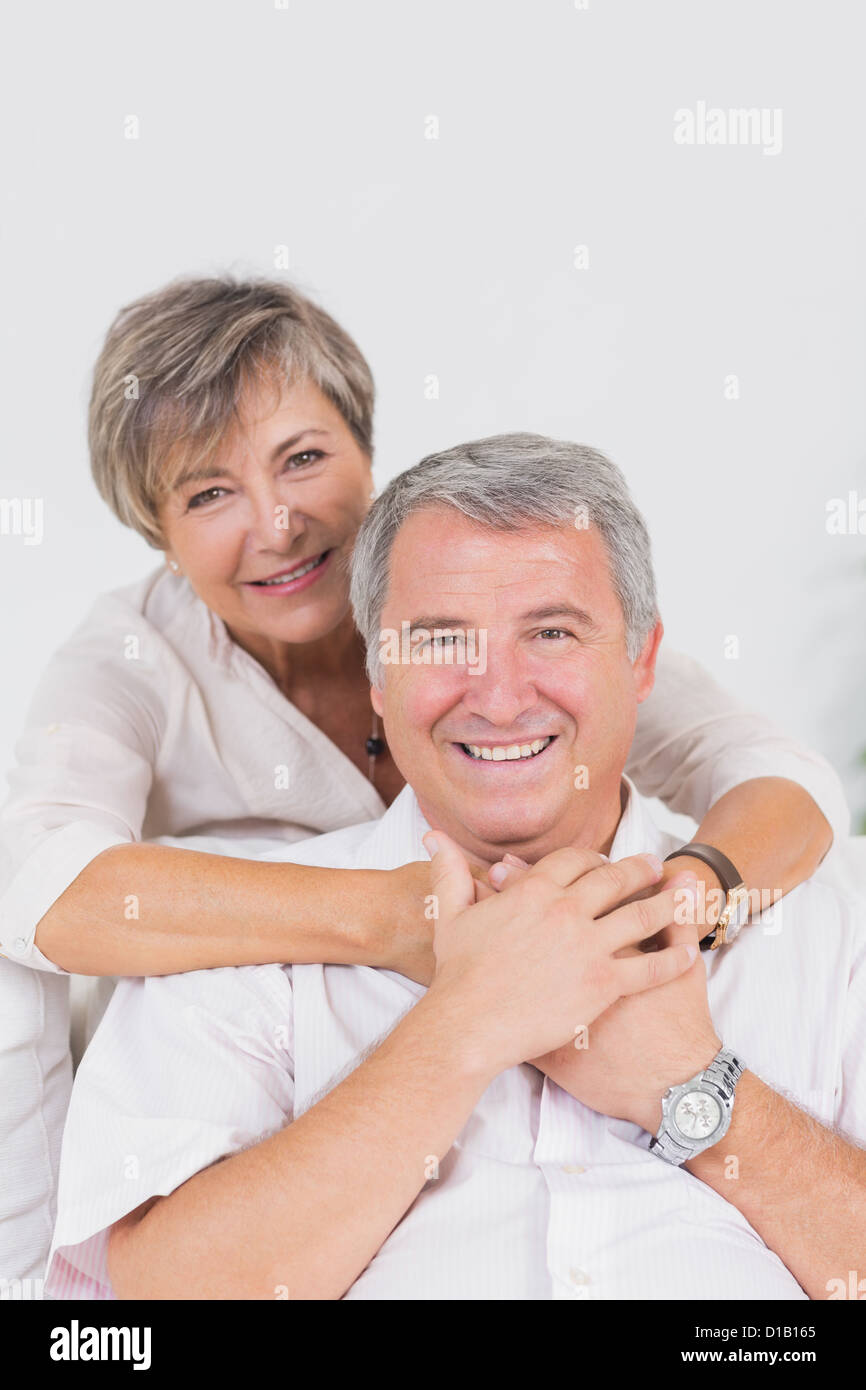Old lovers smiling at the camera and hugging Stock Photo - Alamy