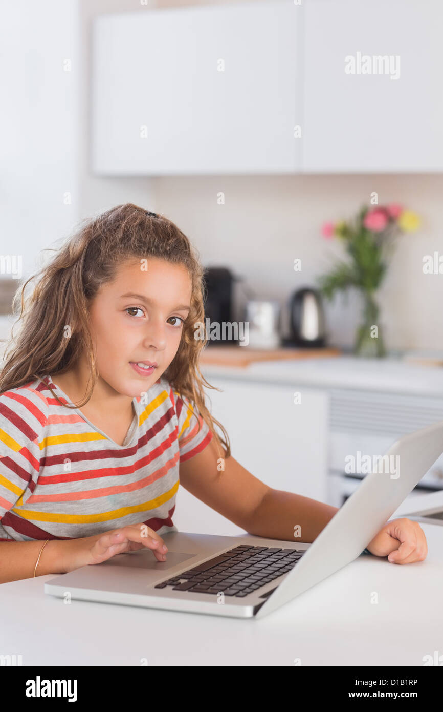 Child looking at the camera with laptop Stock Photo - Alamy