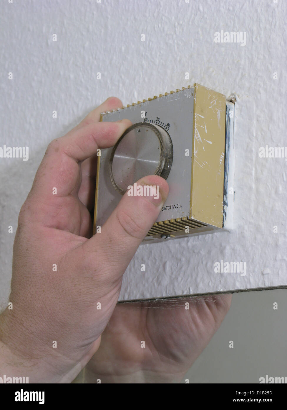 Male hand lowering thermostat temperature hi-res stock photography and ...