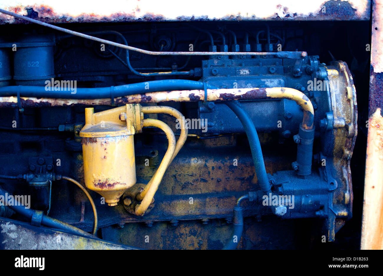 Detail of the engine of an old tractor showing greasy engine parts ...