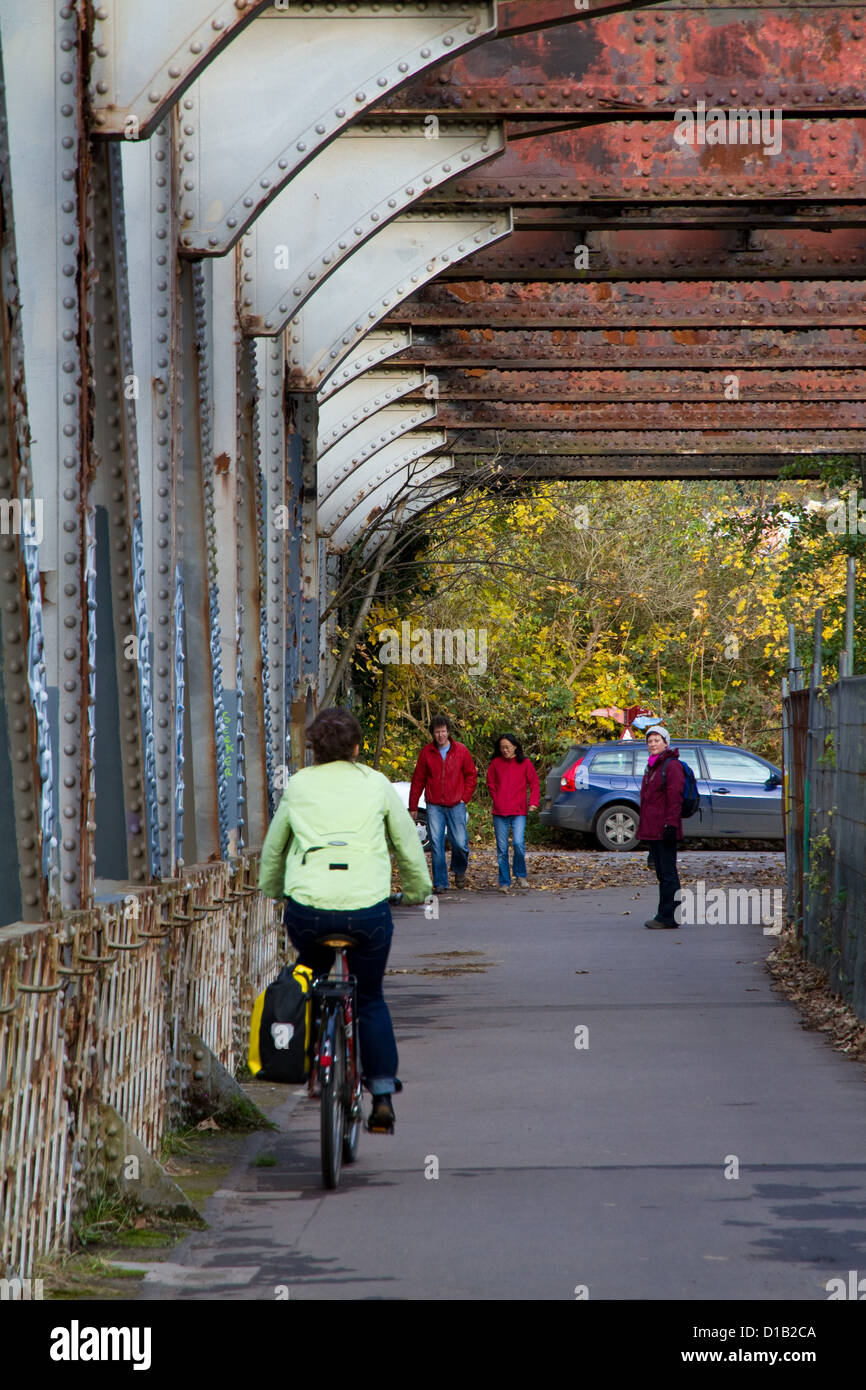 A cyclist heads towards three pedestrians on a cycle/foot path ...