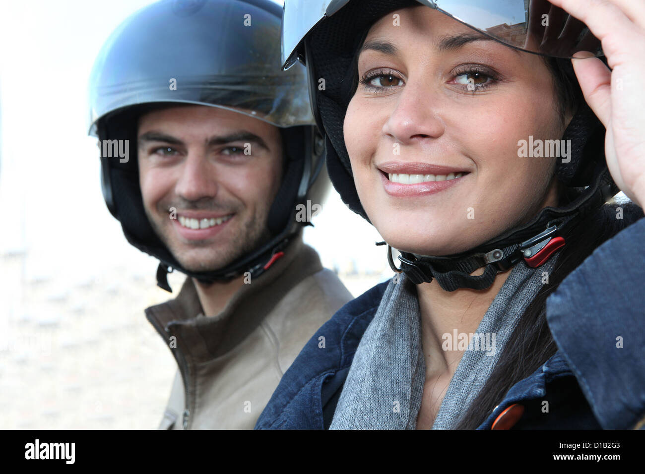 Couple wearing motorbike helmets Stock Photo - Alamy