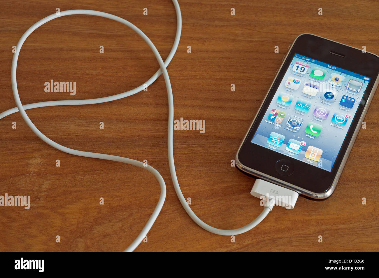 Apple iPhone being recharged Stock Photo - Alamy