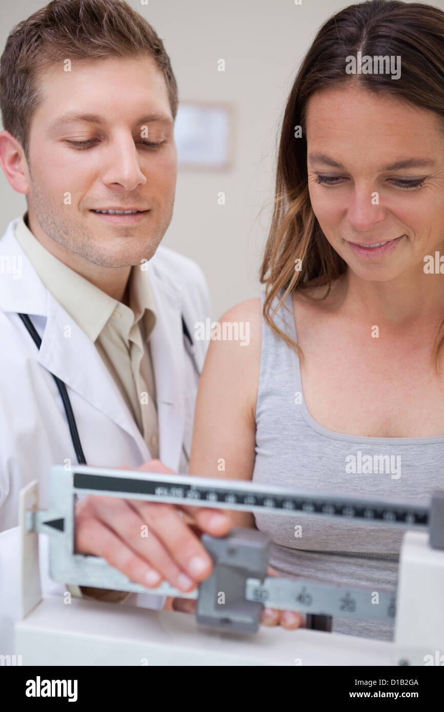 Doctor helping patient to adjust scale Stock Photo - Alamy