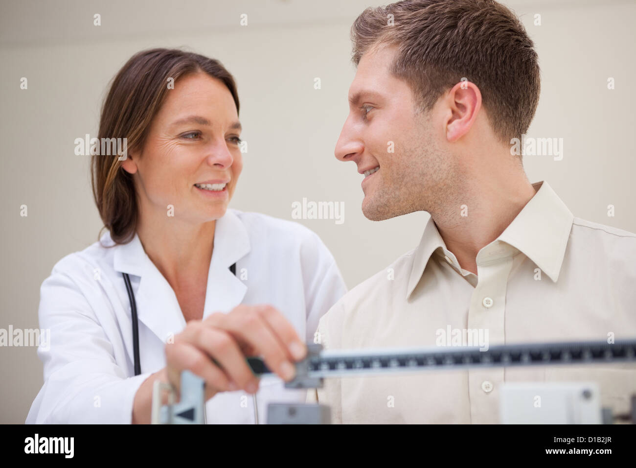 Doctor talking to patient about weight hi-res stock photography and ...