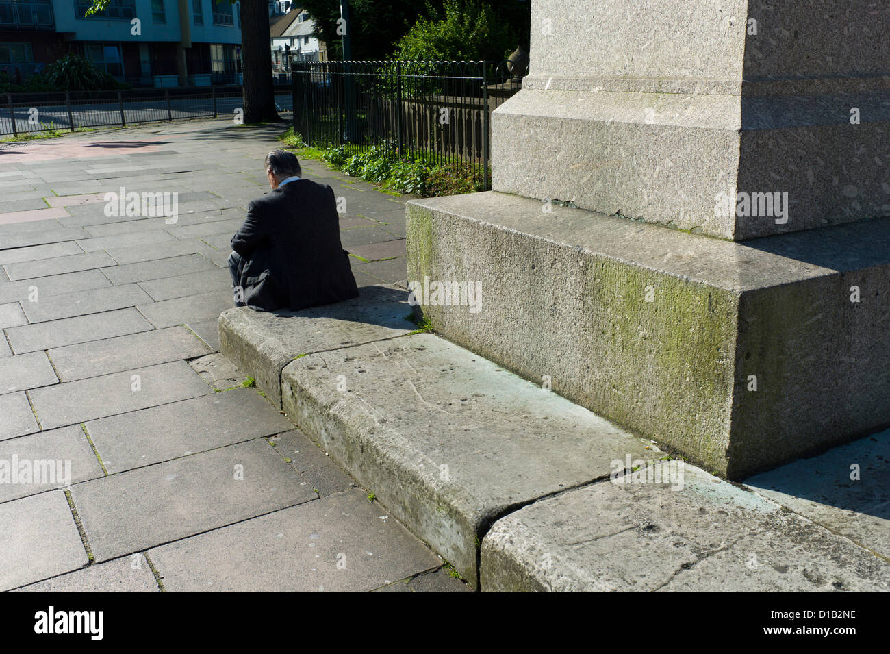 Rear view of man in suit sitting on step,Brighton Stock Photo - Alamy