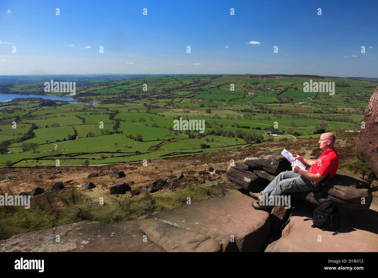 Adult Male walker reading a map by the Sandstone rock formations of the ...