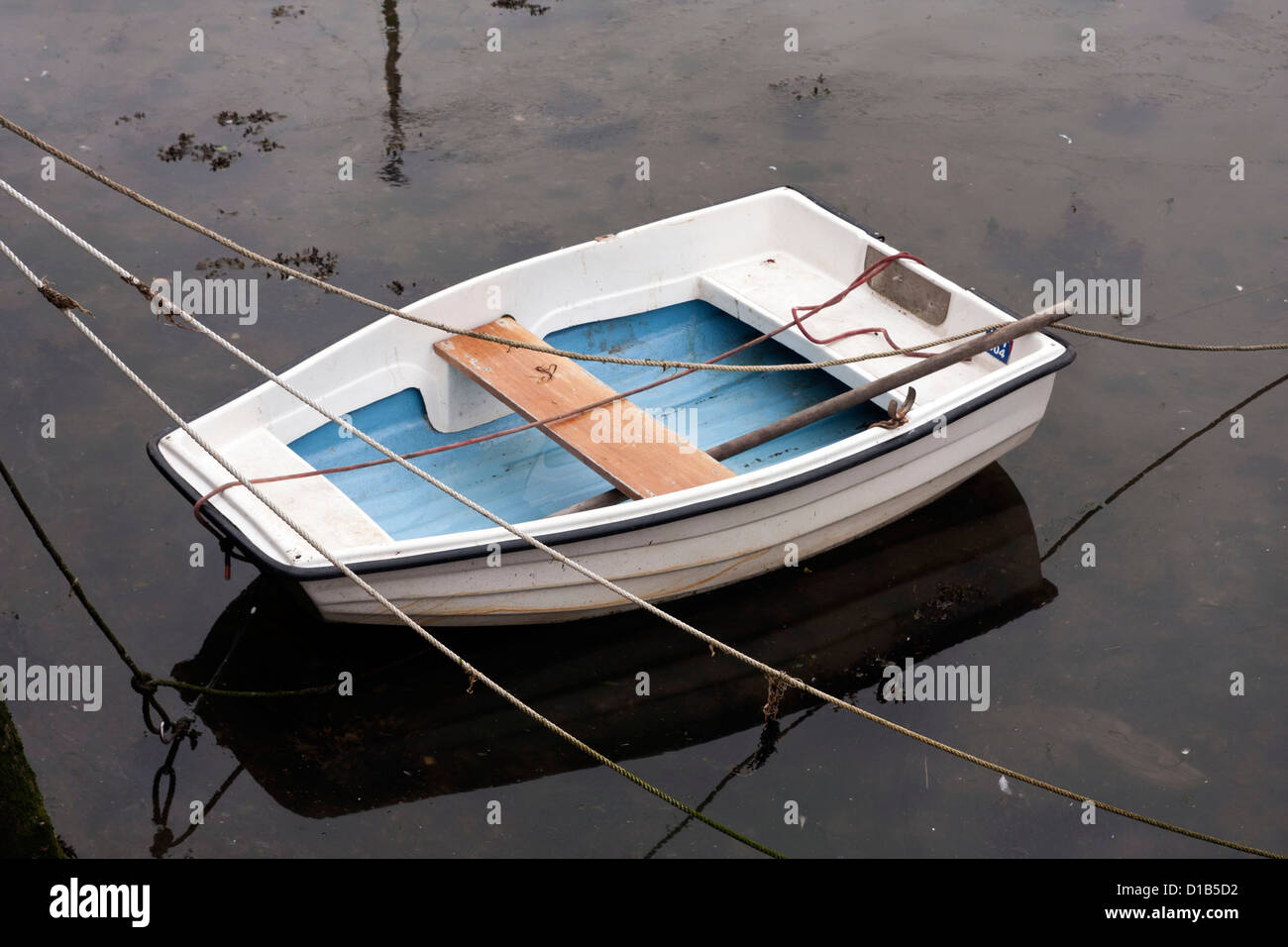 A boat tied with a rope so that it does go away with tide Stock Photo ...