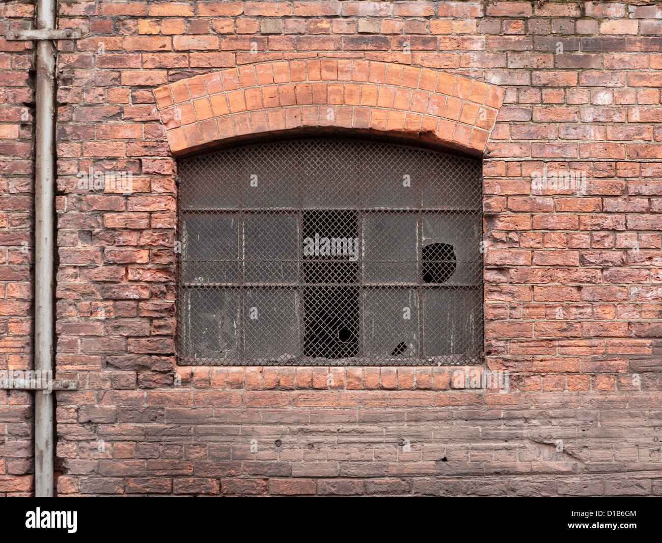 Broken window in a brick wall of an abandoned derelict factory in ...