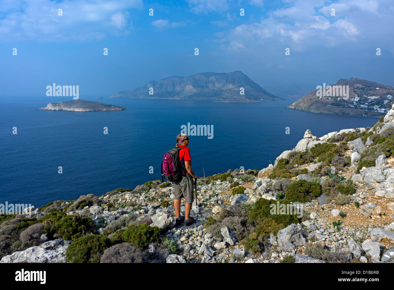 Female walker in red on seaside path, Kalymnos, Greece Stock Photo - Alamy