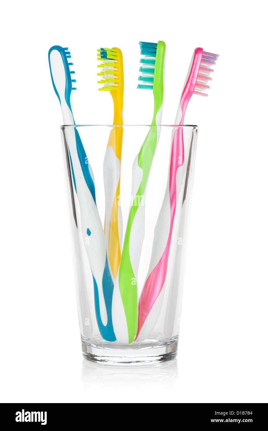 Colorful toothbrushes in glass. Isolated on white background Stock ...