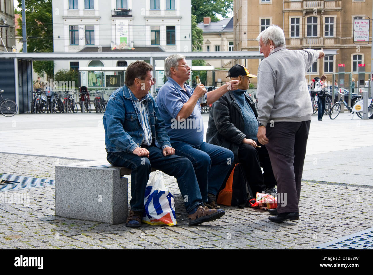 Leipzig, Germany, men sit on a bench on the street Stock Photo - Alamy