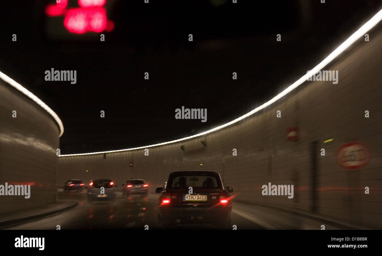 Munich, Germany, cars are driving into a underpass at night and rain ...