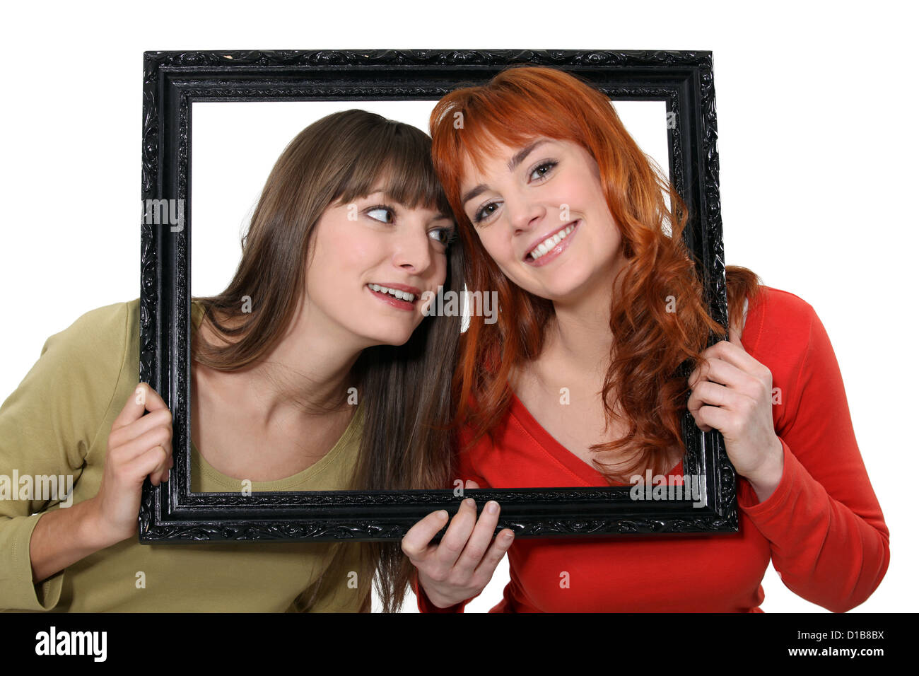 Two girls behind black frame Stock Photo - Alamy
