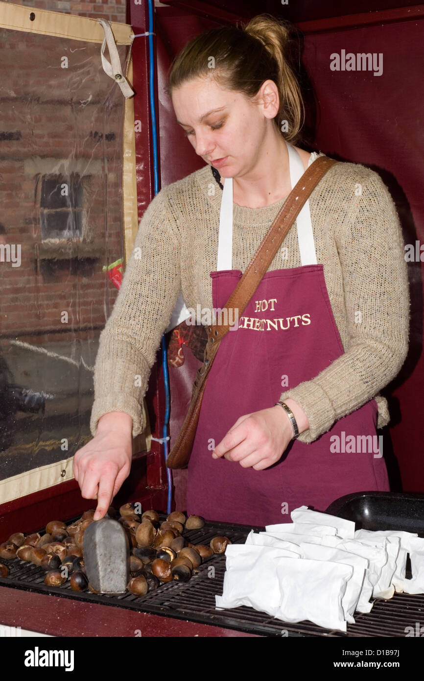 woman selling fresh hot chestnuts from a stall at the victorian ...