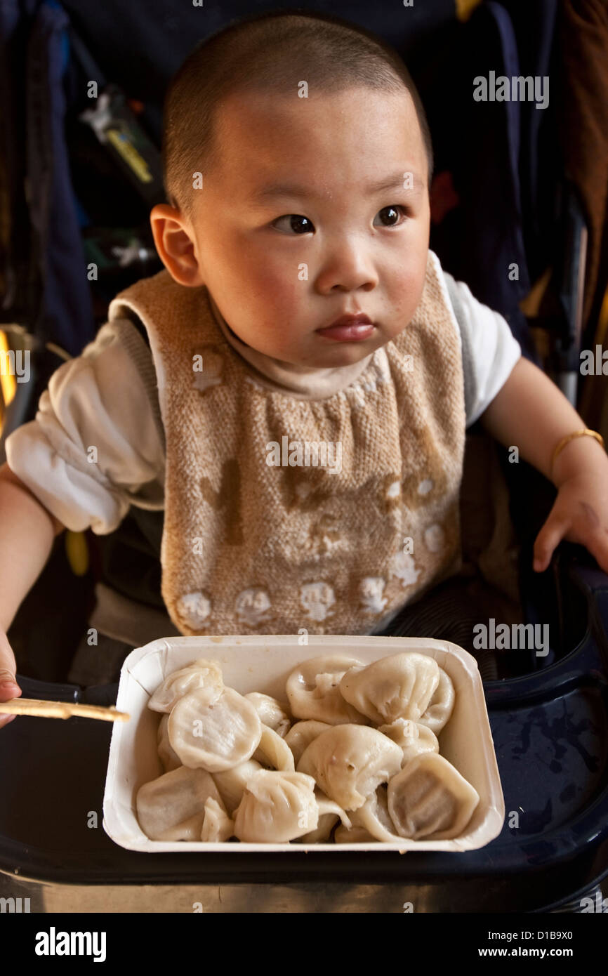 Baby Eating Dumplings, Shanghai, China Stock Photo - Alamy