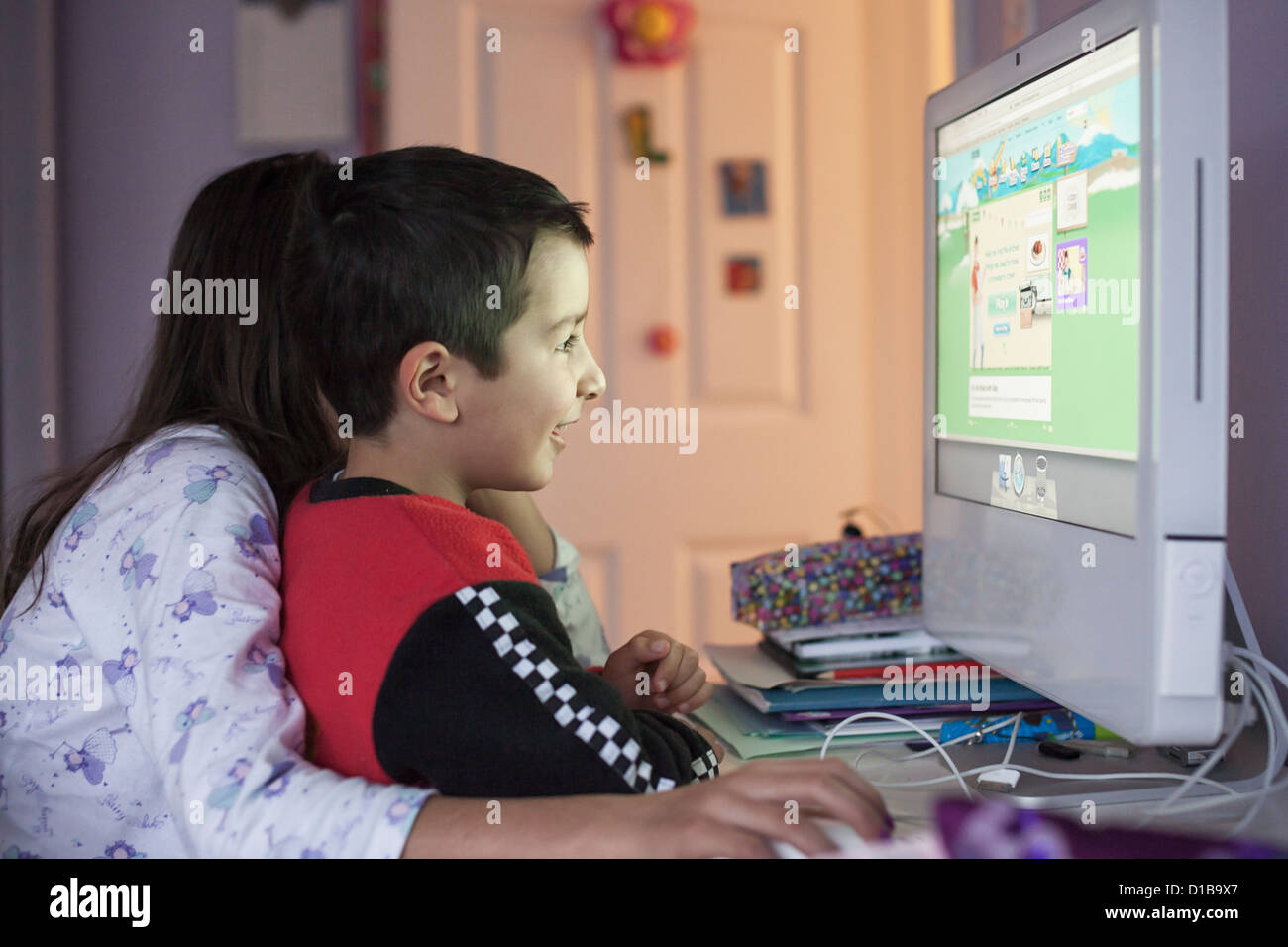 Two siblings playing on the computer together Stock Photo - Alamy