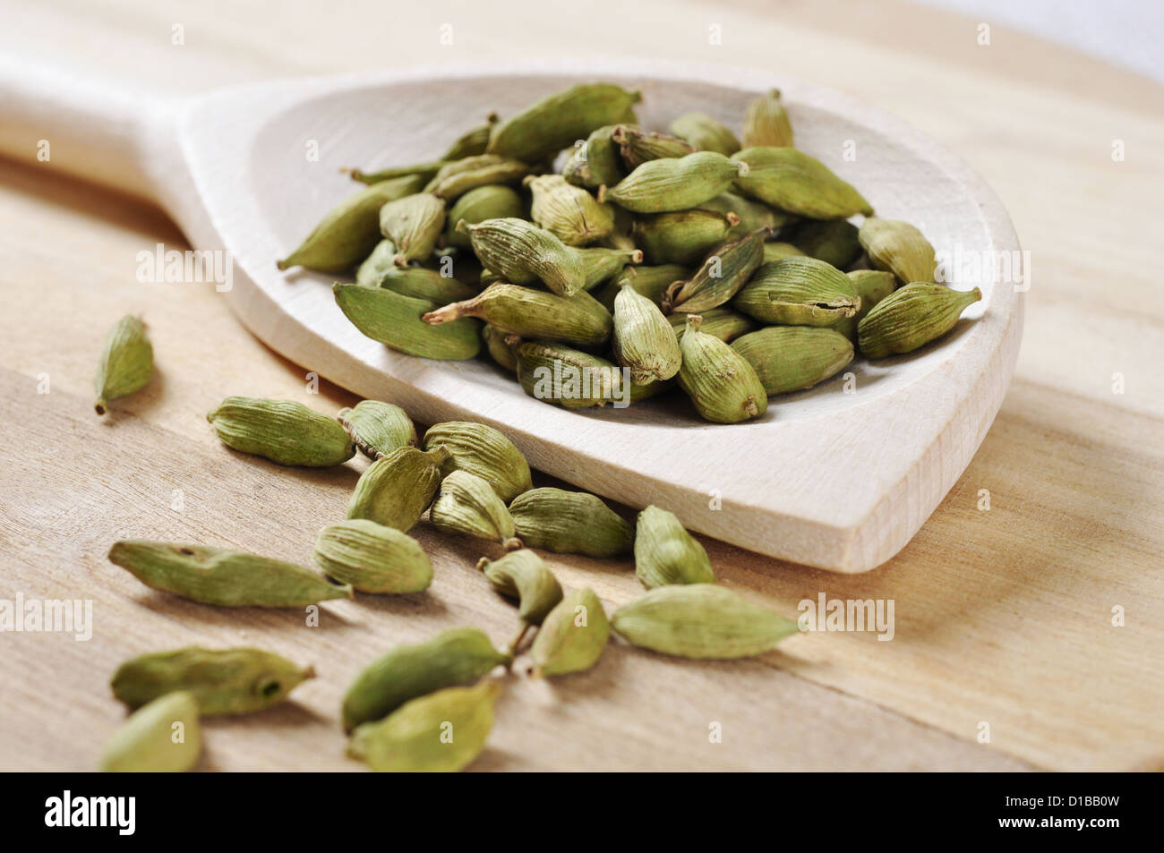 Green Cardamom Pods on wooden background closeup Stock Photo - Alamy