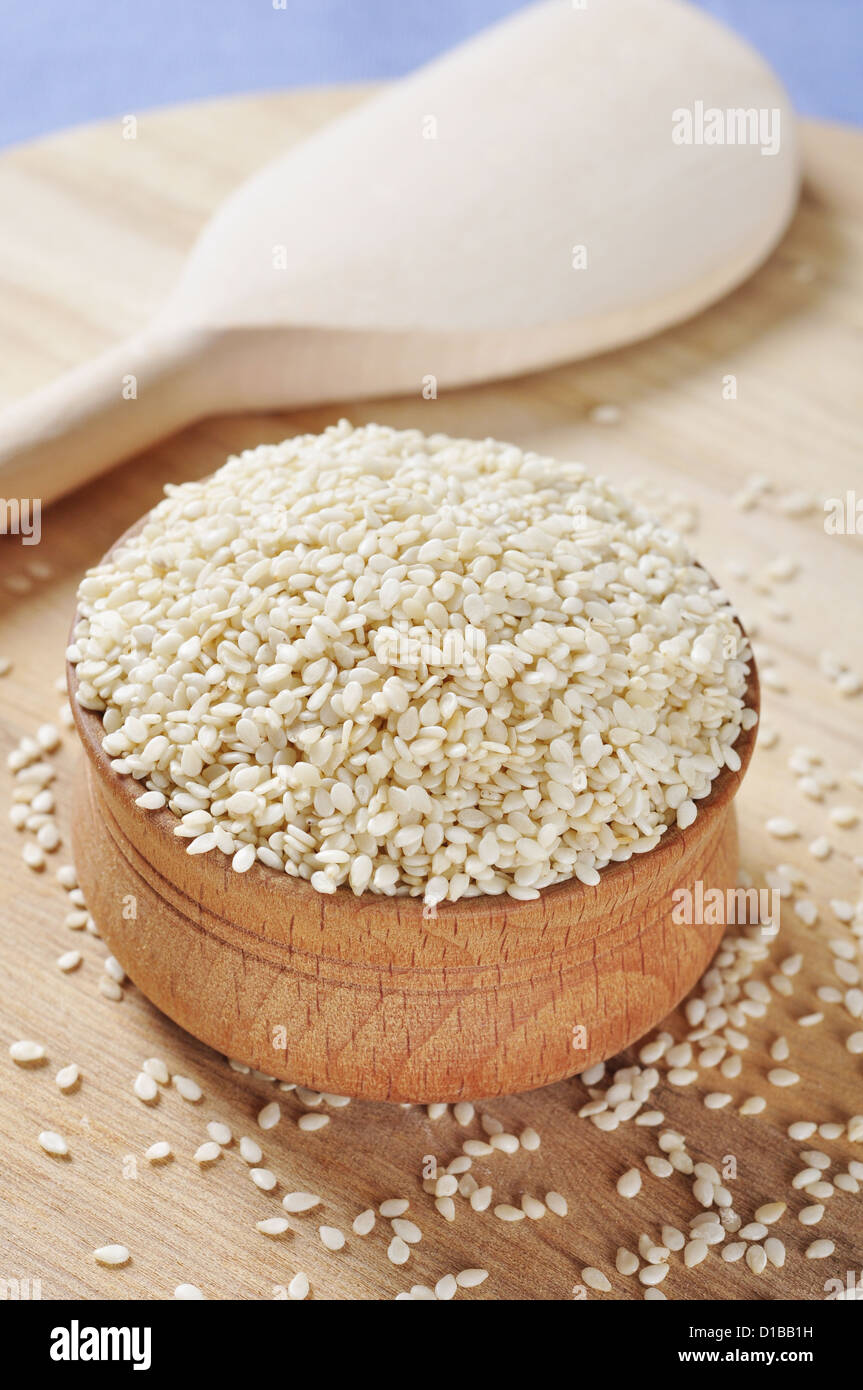 Sesame seeds in wooden bowl closeup Stock Photo - Alamy