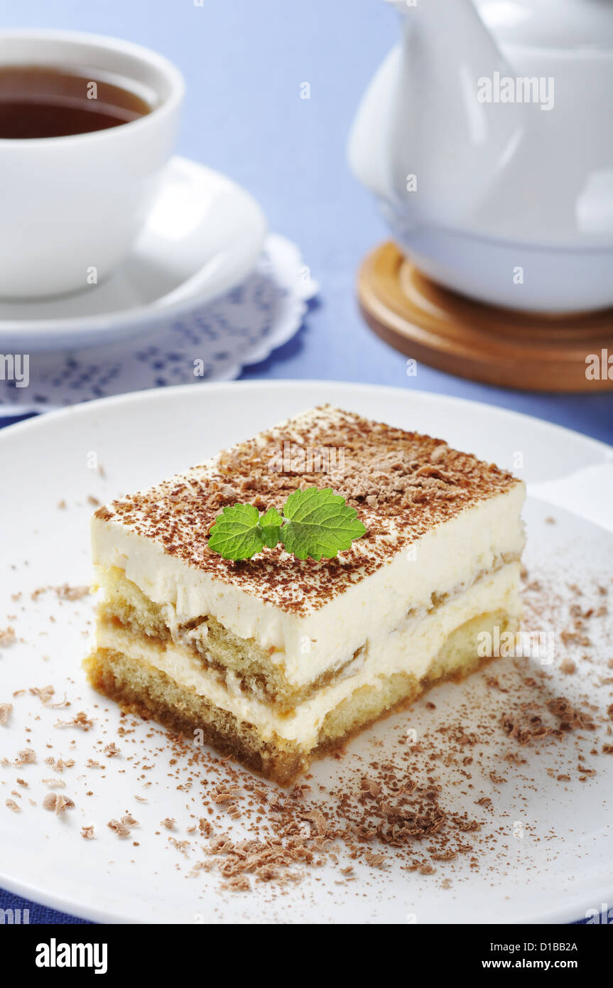 Tiramisu - Classical Dessert with Coffee on white plate. Garnished with ...