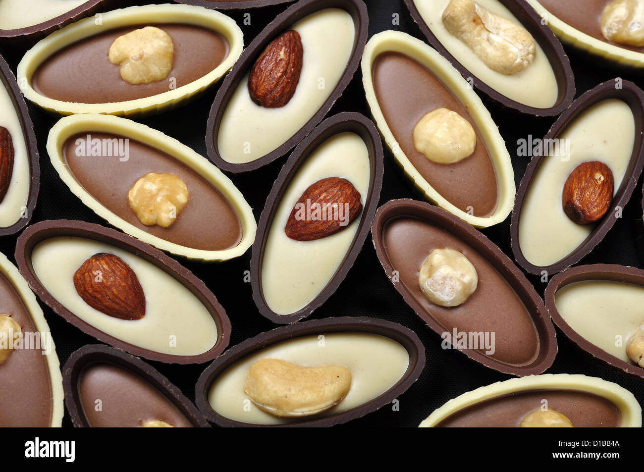 Assorted chocolate candies with different nuts, closeup Stock Photo - Alamy
