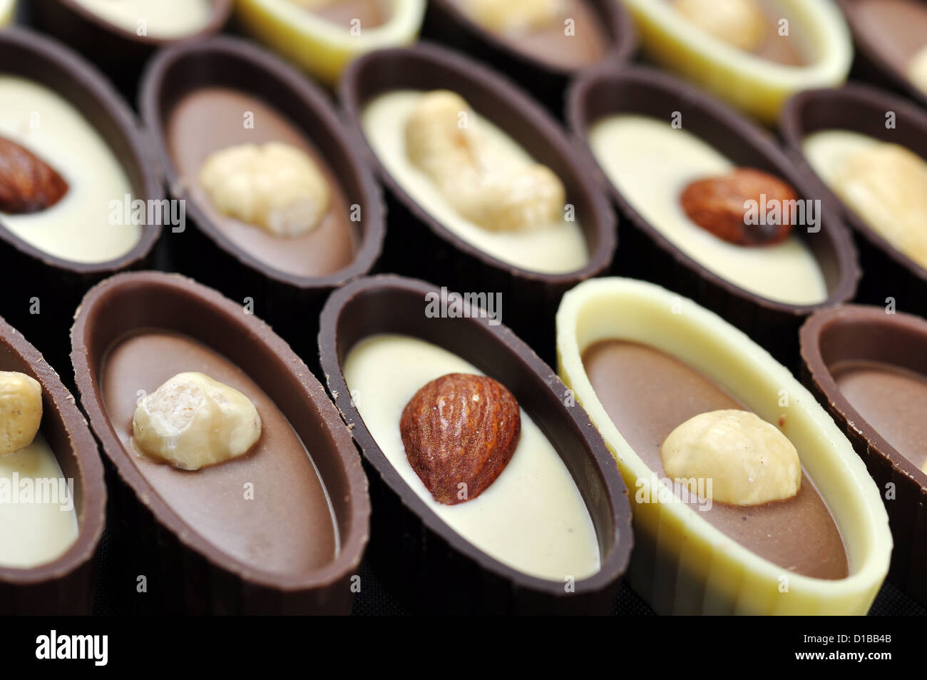 Assorted chocolate candies with different nuts, closeup Stock Photo - Alamy