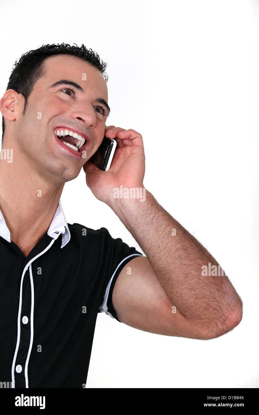 Man on the phone laughing Stock Photo - Alamy