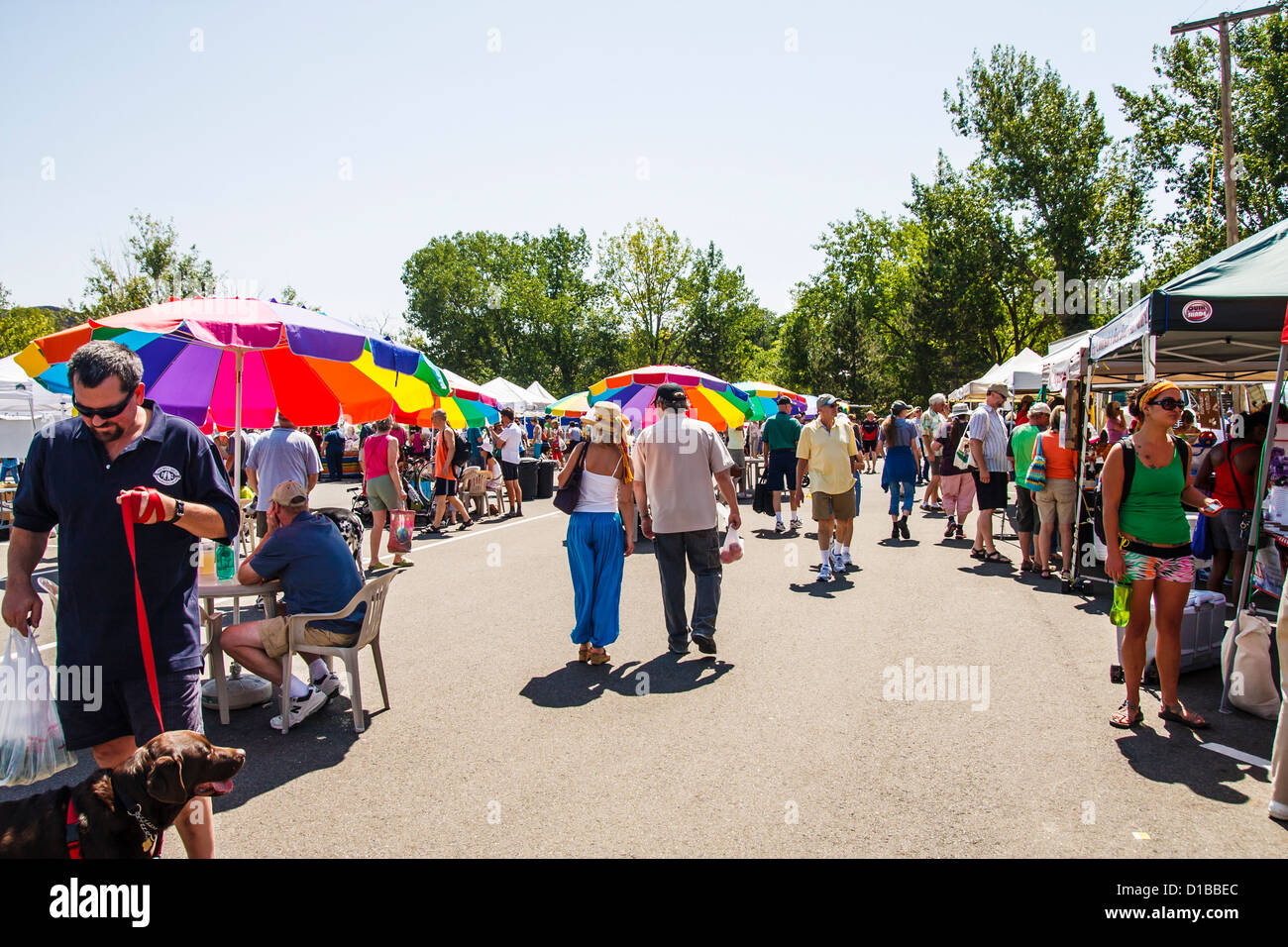 An outdoor festival with many people and colorful umbrellas Stock Photo ...