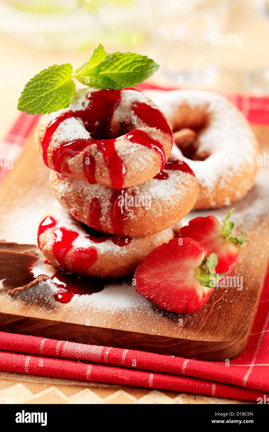 Ring donuts with strawberry syrup Stock Photo - Alamy