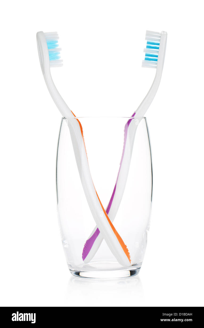 Two toothbrushes in a glass. Isolated on white background Stock Photo ...